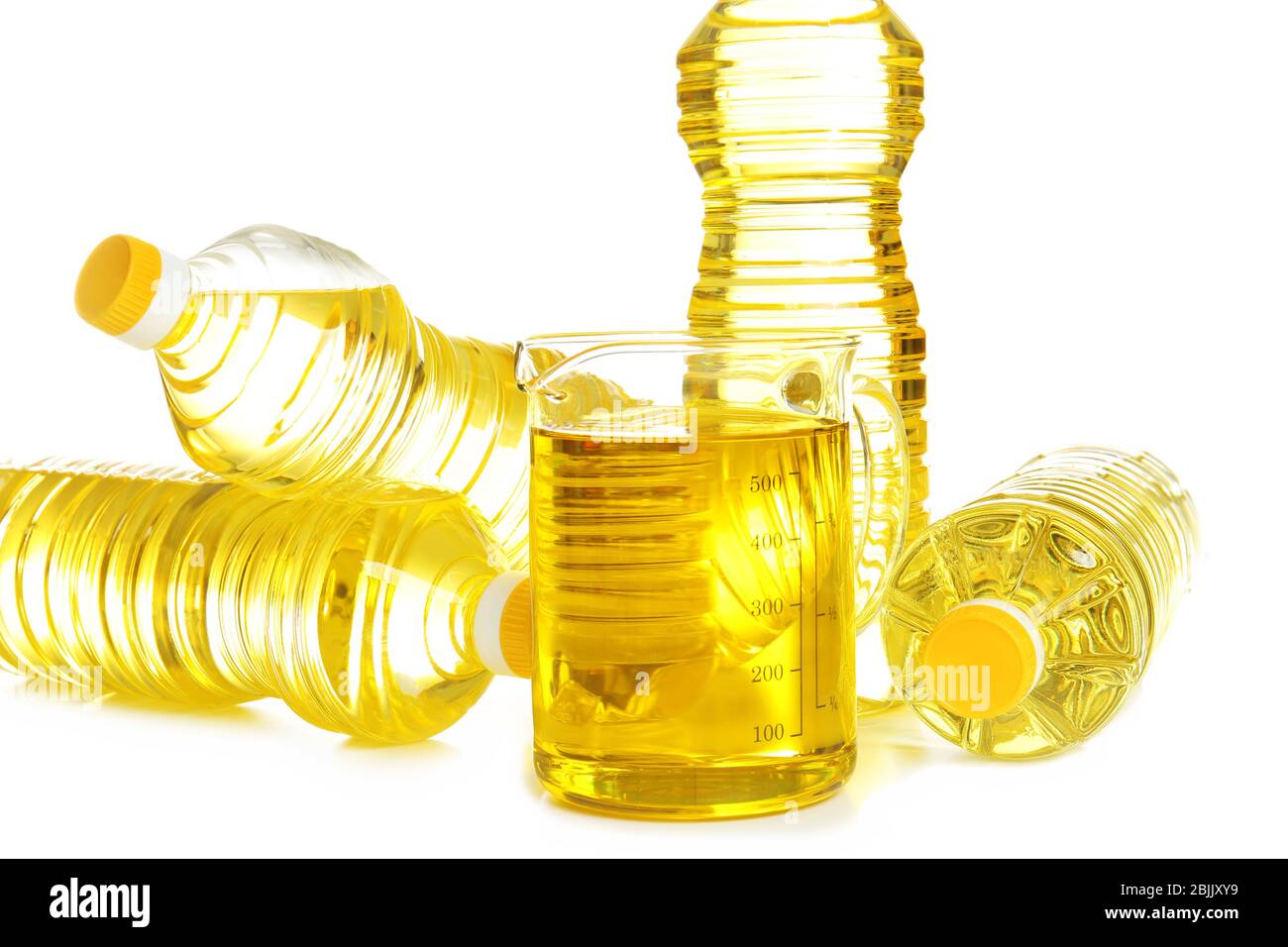 Beaker and bottles of cooking oil on white background Stock Photo - Alamy