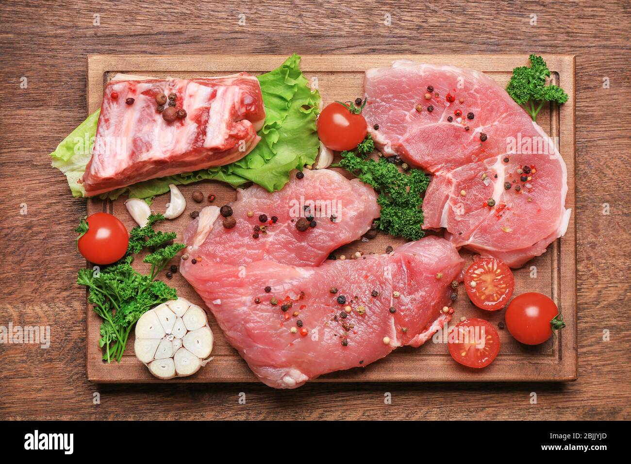Wooden board with different types of meat on table Stock Photo - Alamy