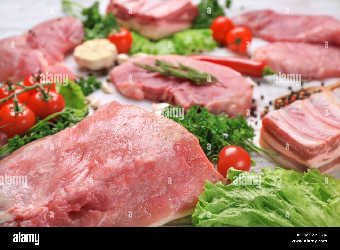 Different types of meat on wooden table Stock Photo - Alamy