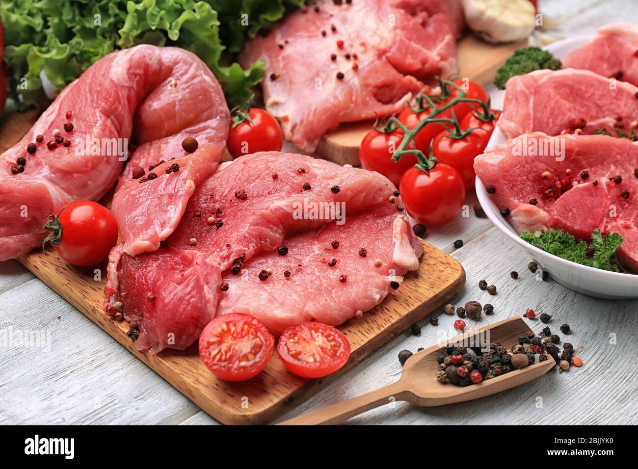 Different types of raw meat on wooden table Stock Photo - Alamy