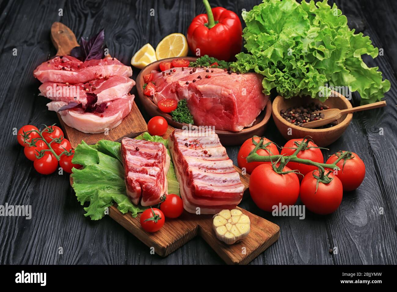 Different types of raw meat on wooden table Stock Photo - Alamy