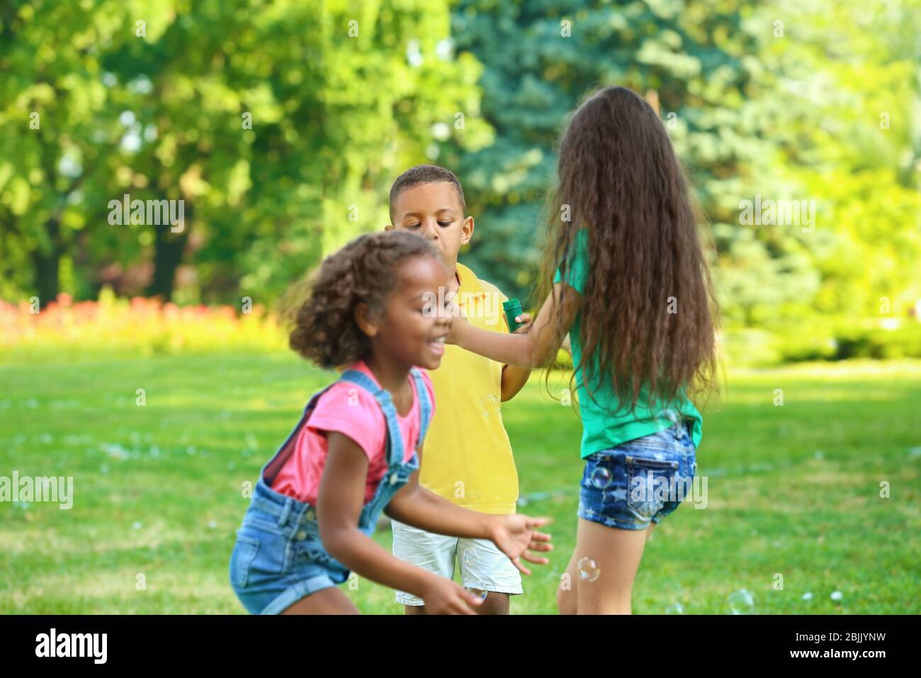 Cute little children playing outdoors Stock Photo - Alamy