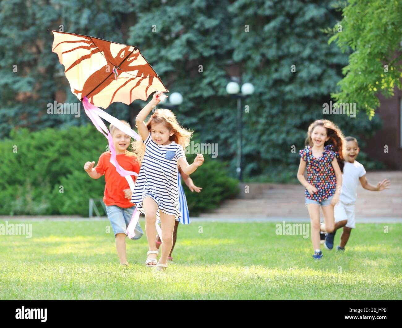 Cute little children playing with kite outdoors Stock Photo - Alamy