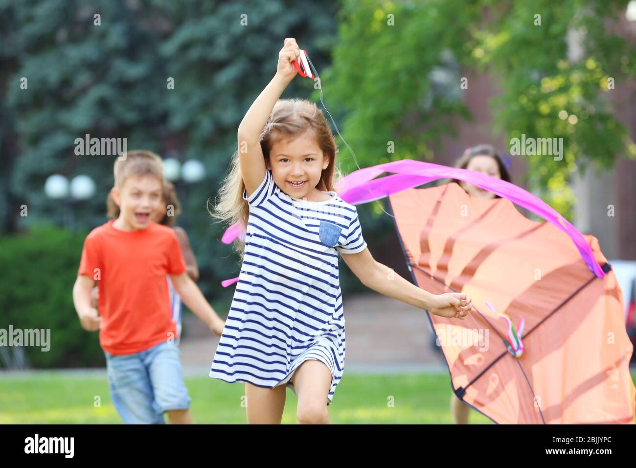 Cute little children playing with kite outdoors Stock Photo - Alamy