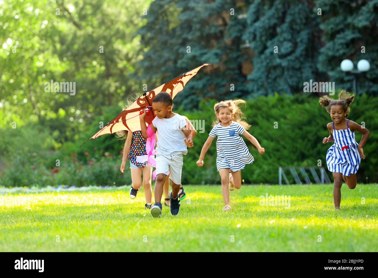 Cute little children playing with kite outdoors Stock Photo - Alamy