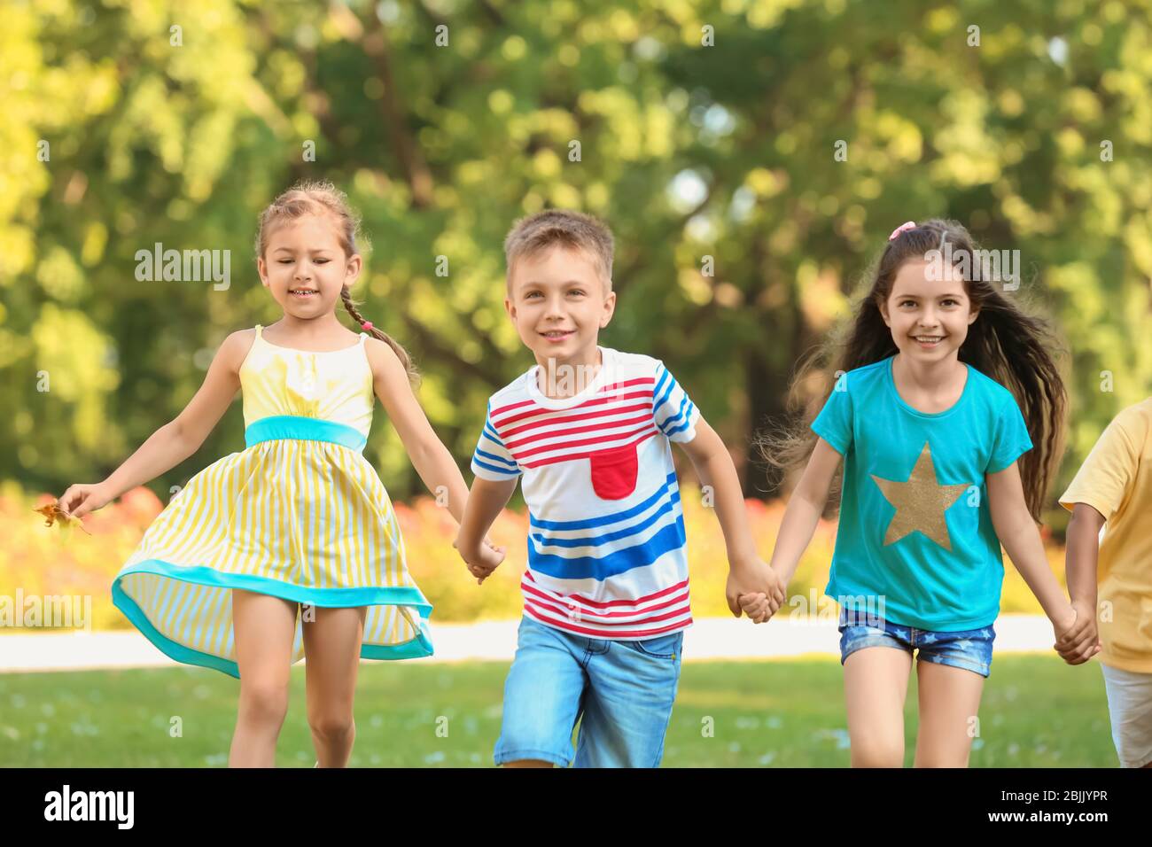 Cute little children playing in park Stock Photo - Alamy