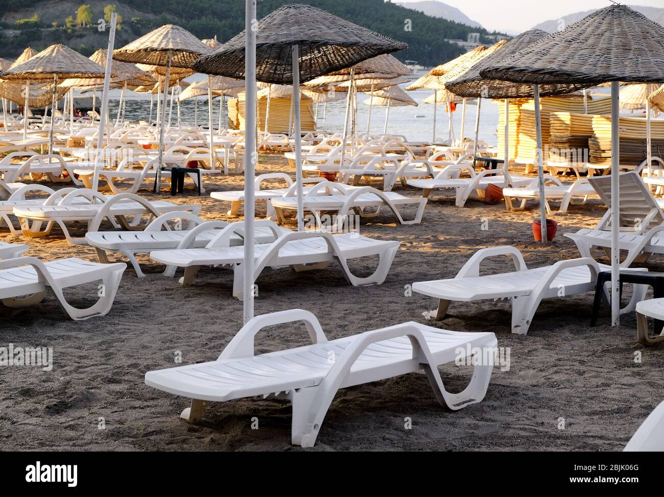 Comfortable sun loungers on sea beach at resort Stock Photo - Alamy