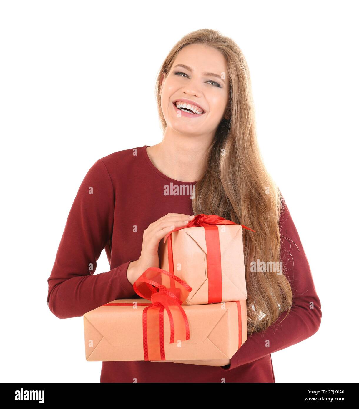 Attractive young lady holding gift boxes against white background Stock ...