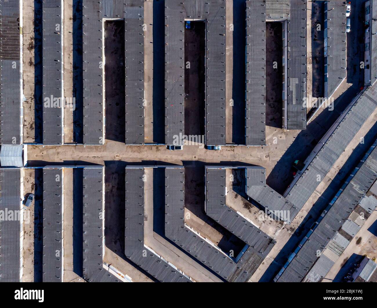 Aerial top down view of many concrete garages for car parking in ...