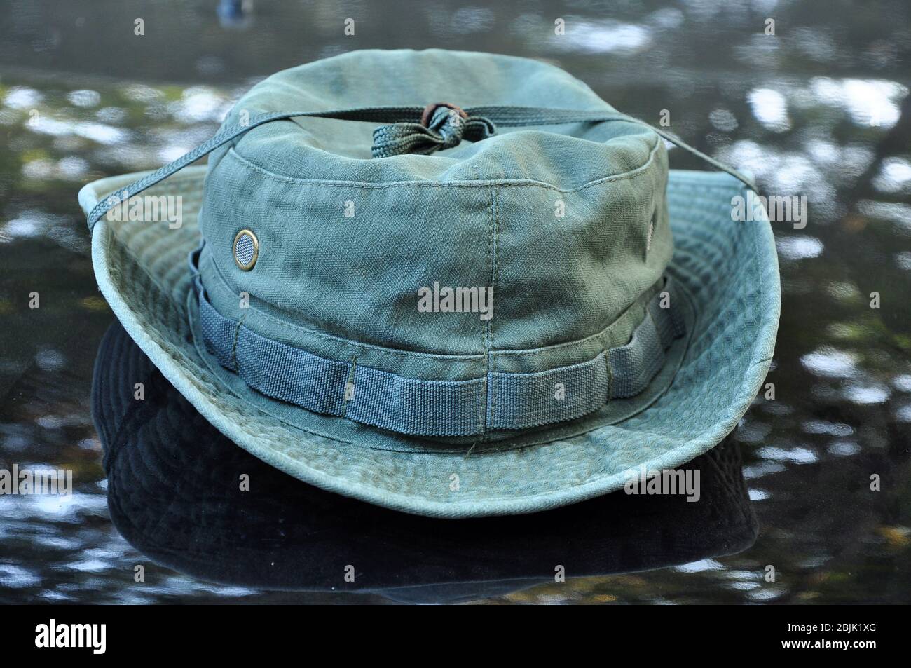 Green military boonie hat on black background Stock Photo - Alamy