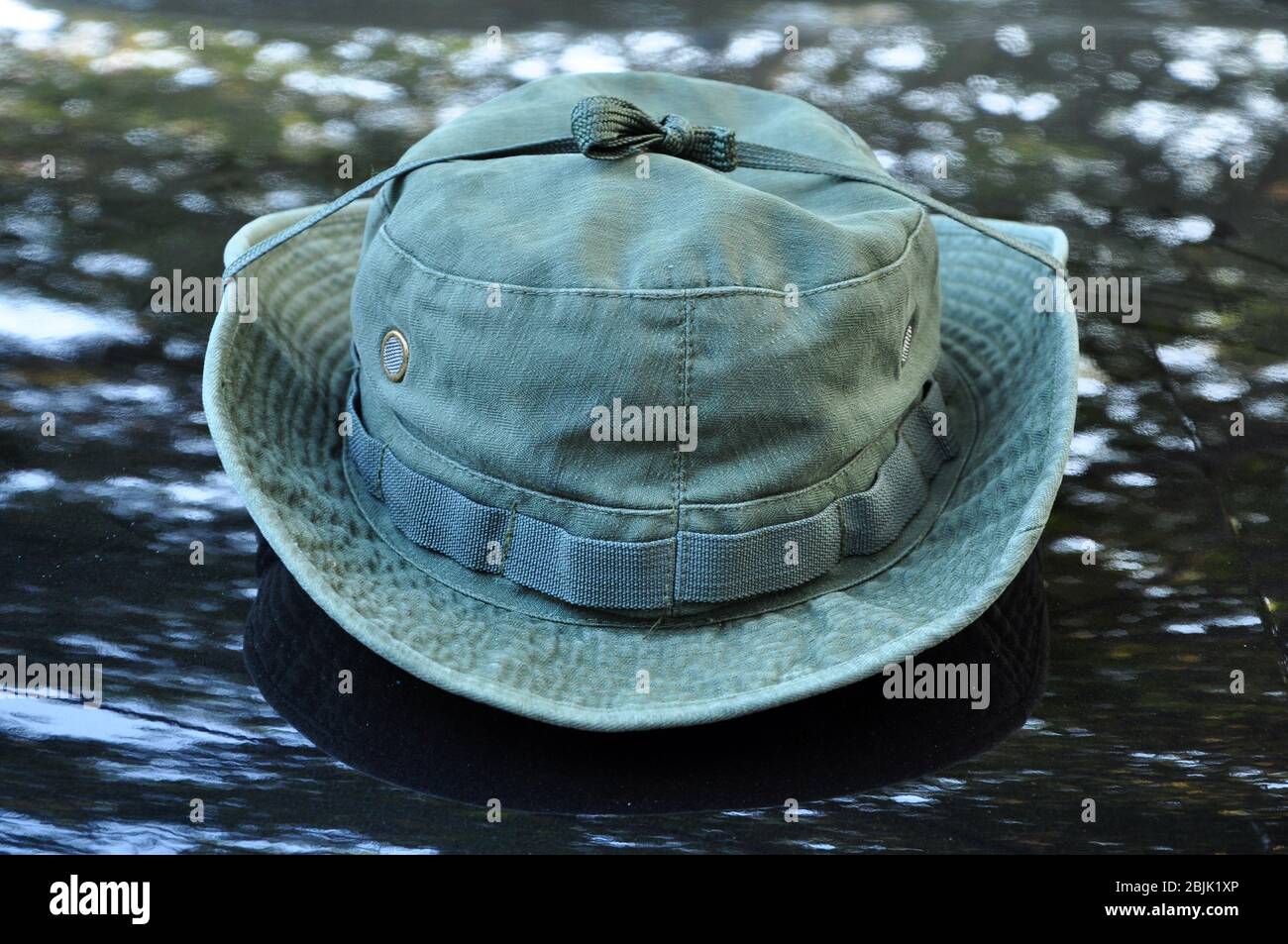 Green military boonie hat on black background Stock Photo - Alamy