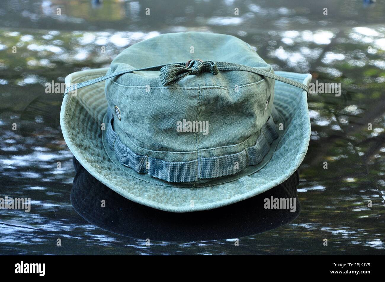 Green military boonie hat on black background Stock Photo - Alamy