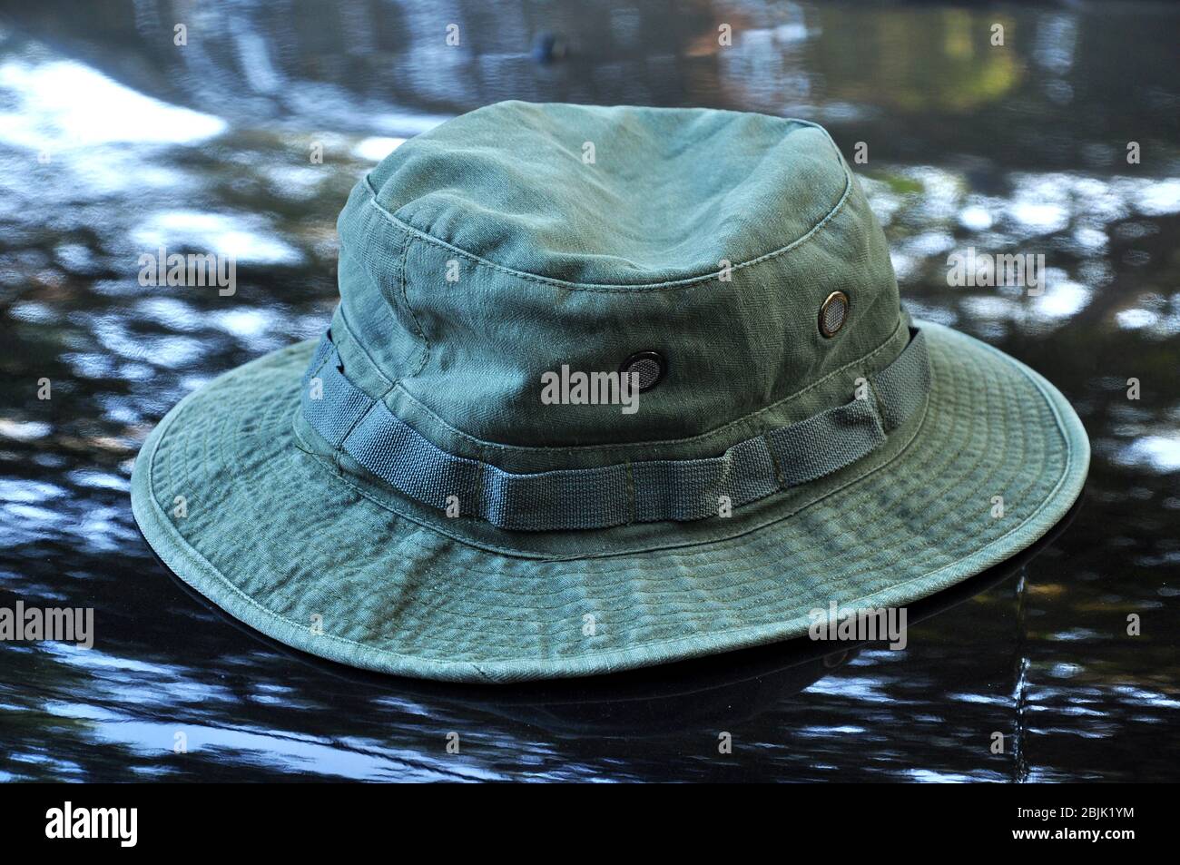 Green military boonie hat on black background Stock Photo - Alamy