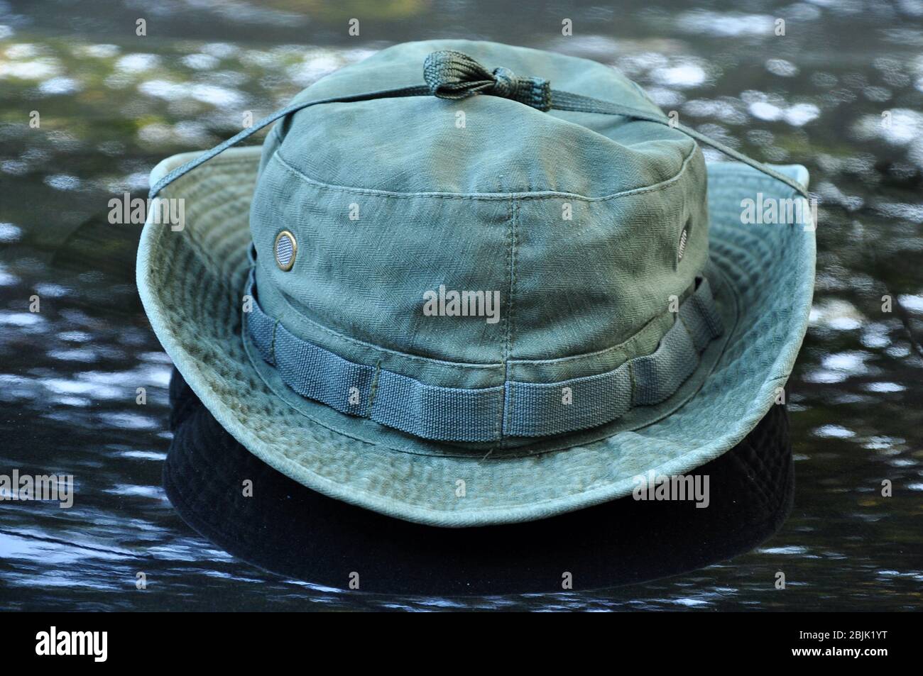 Green military boonie hat on black background Stock Photo - Alamy