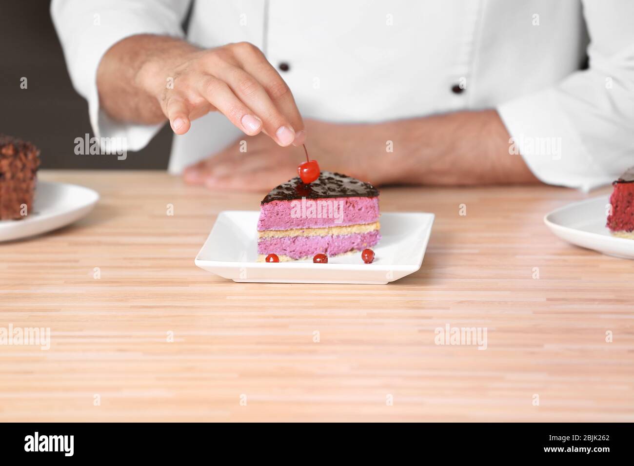 Young male chef decorating tasty dessert in kitchen Stock Photo - Alamy