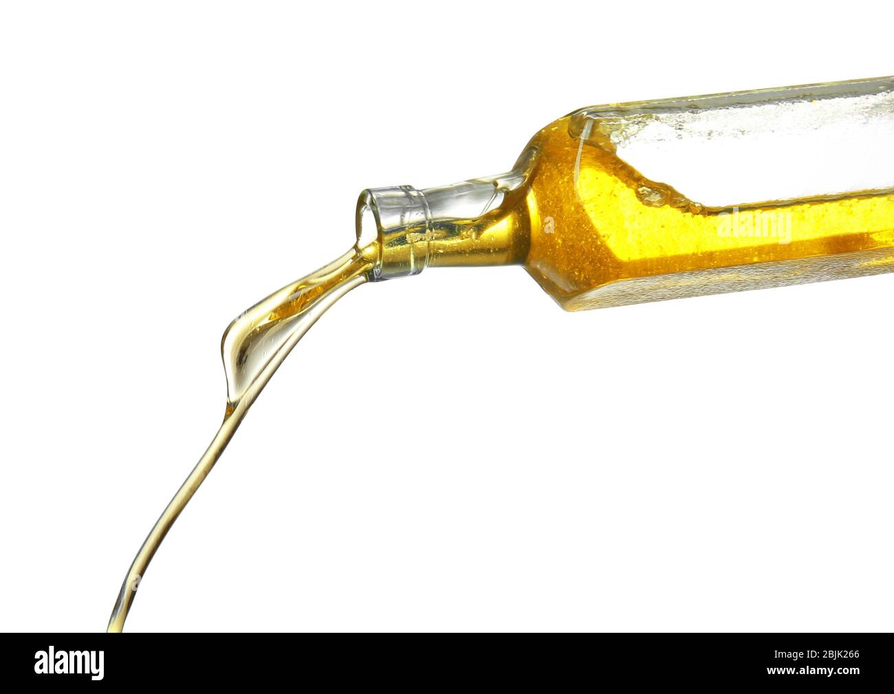Pouring cooking oil from bottle on white background Stock Photo - Alamy