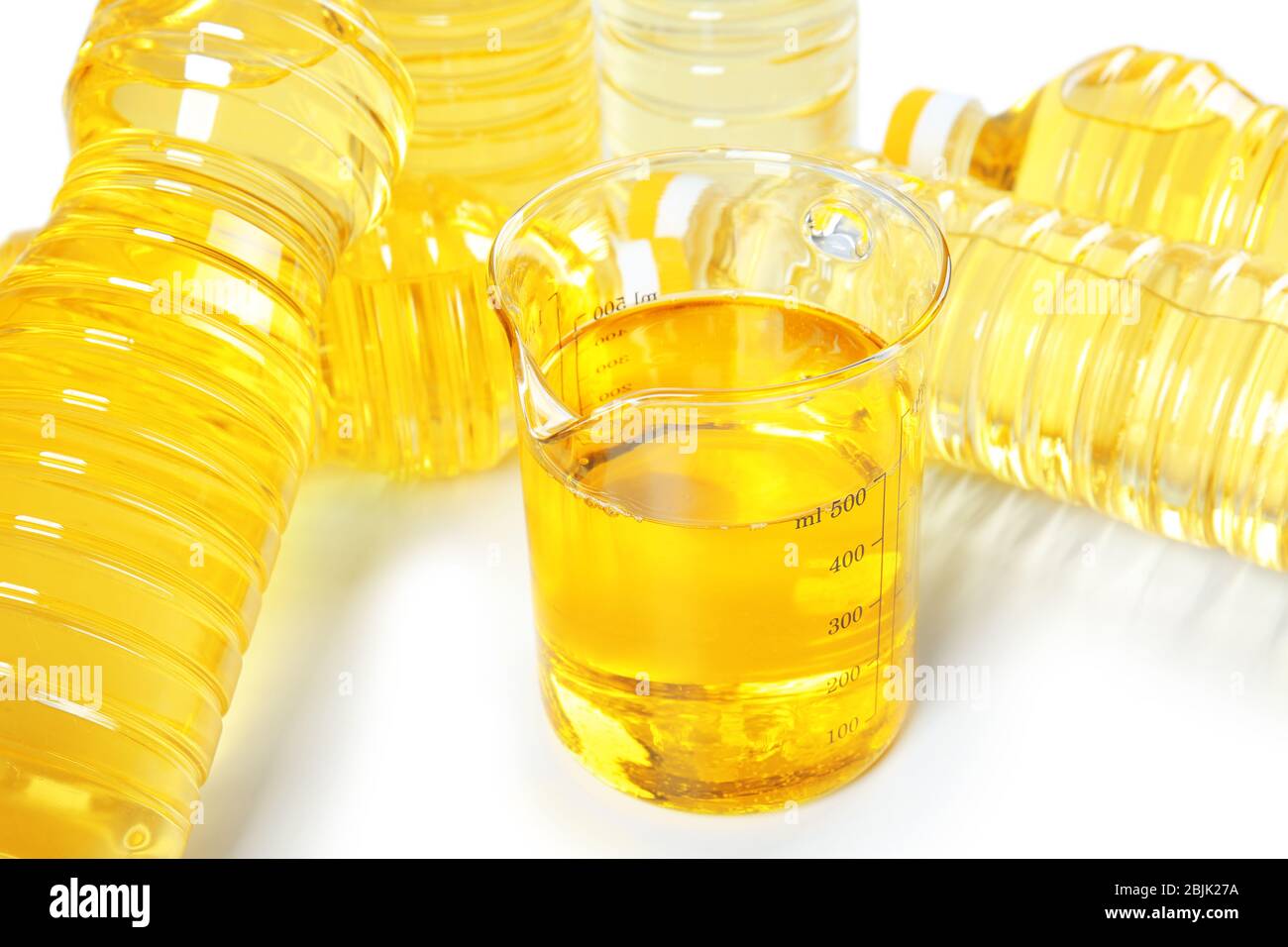 Beaker and bottles with cooking oil on white background Stock Photo - Alamy