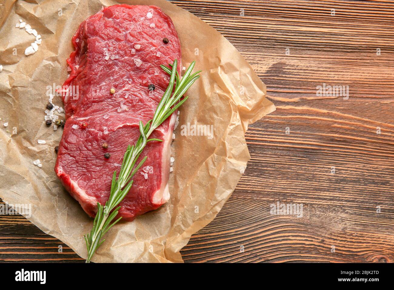 Fresh raw meat with spice on parchment paper Stock Photo - Alamy