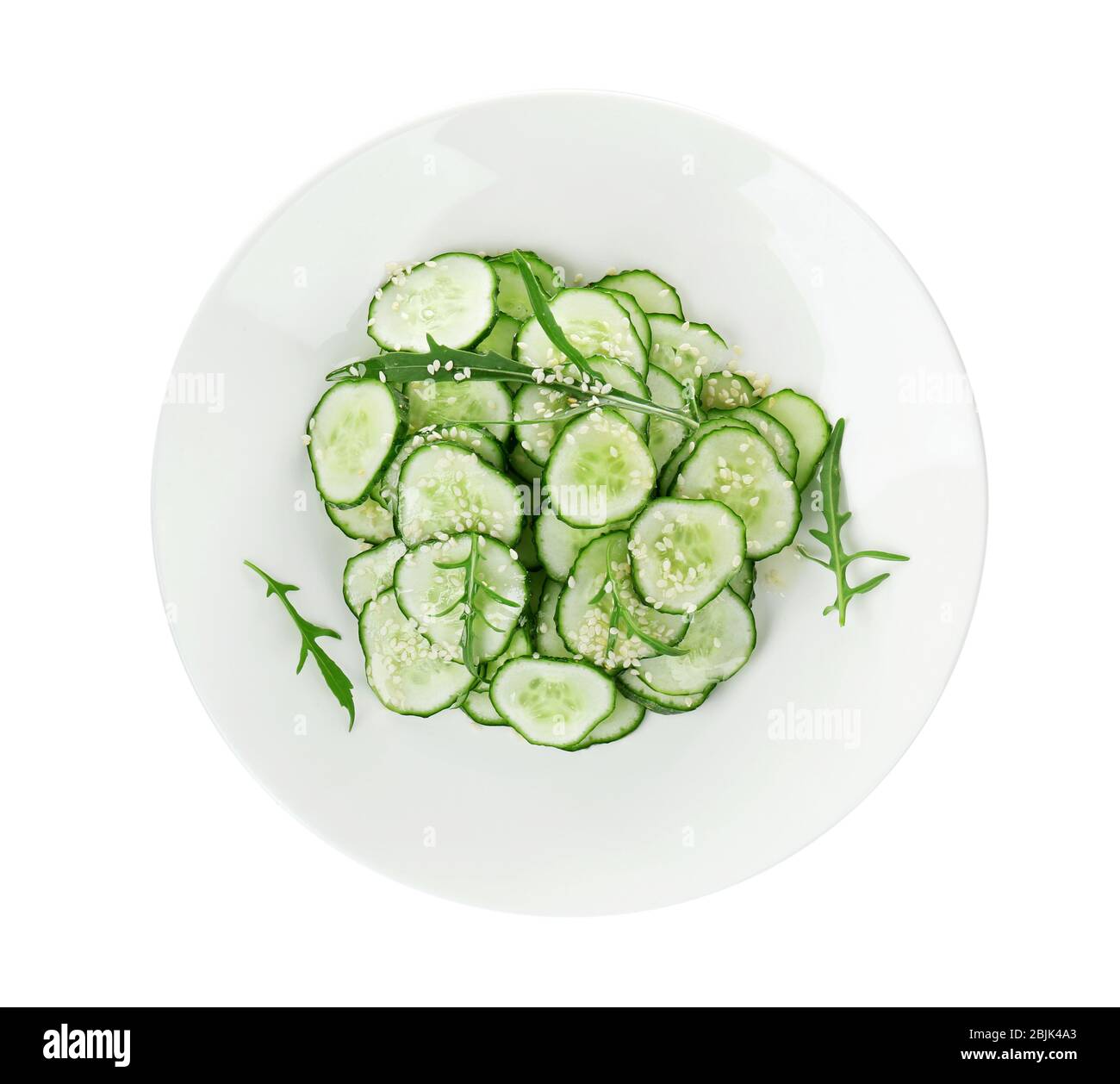 Fresh cucumber salad on plate, isolated on white Stock Photo - Alamy