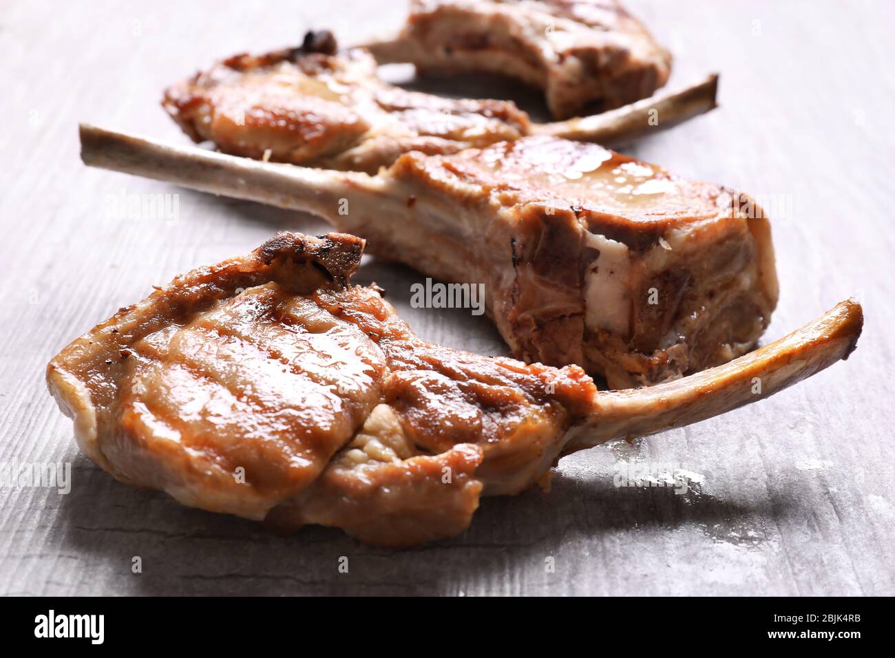 Delicious ribs on wooden table Stock Photo - Alamy