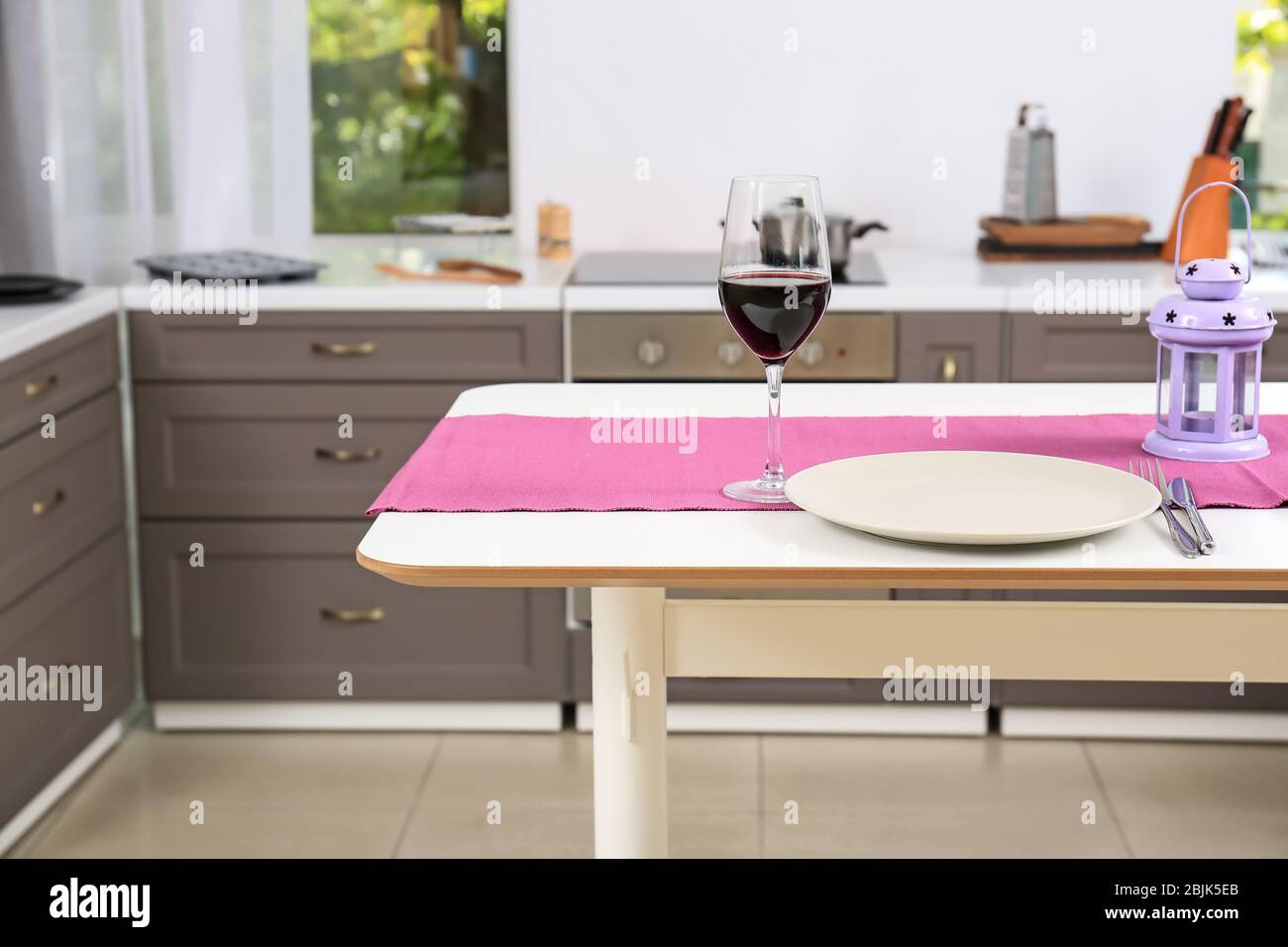 Stylish table in modern kitchen Stock Photo - Alamy