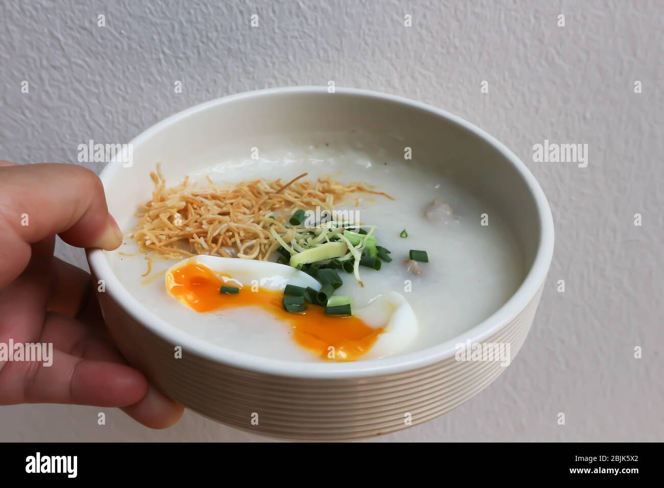 serving rice gruel, rice porridge or congee Stock Photo - Alamy