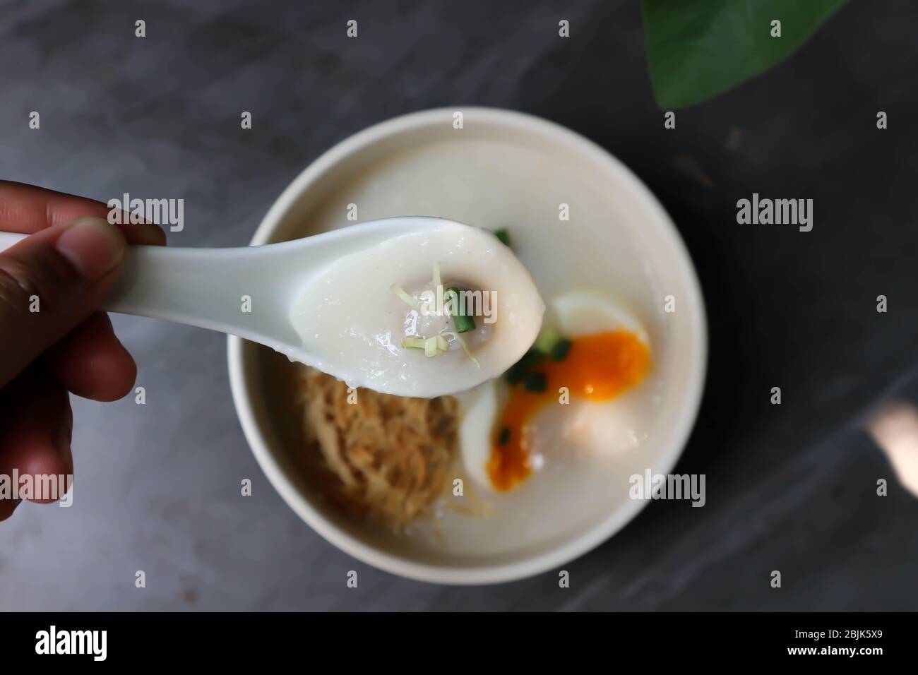 eating rice gruel, rice porridge or congee Stock Photo - Alamy