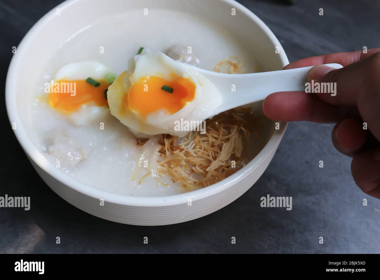 eating rice gruel, rice porridge or congee Stock Photo - Alamy