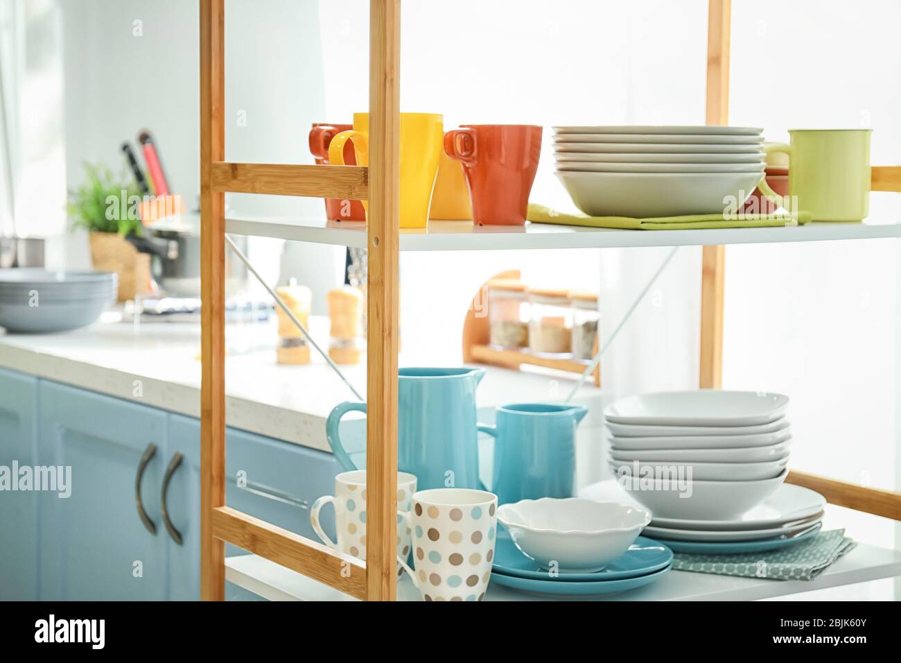 Shelving with different clean dishes in kitchen Stock Photo - Alamy