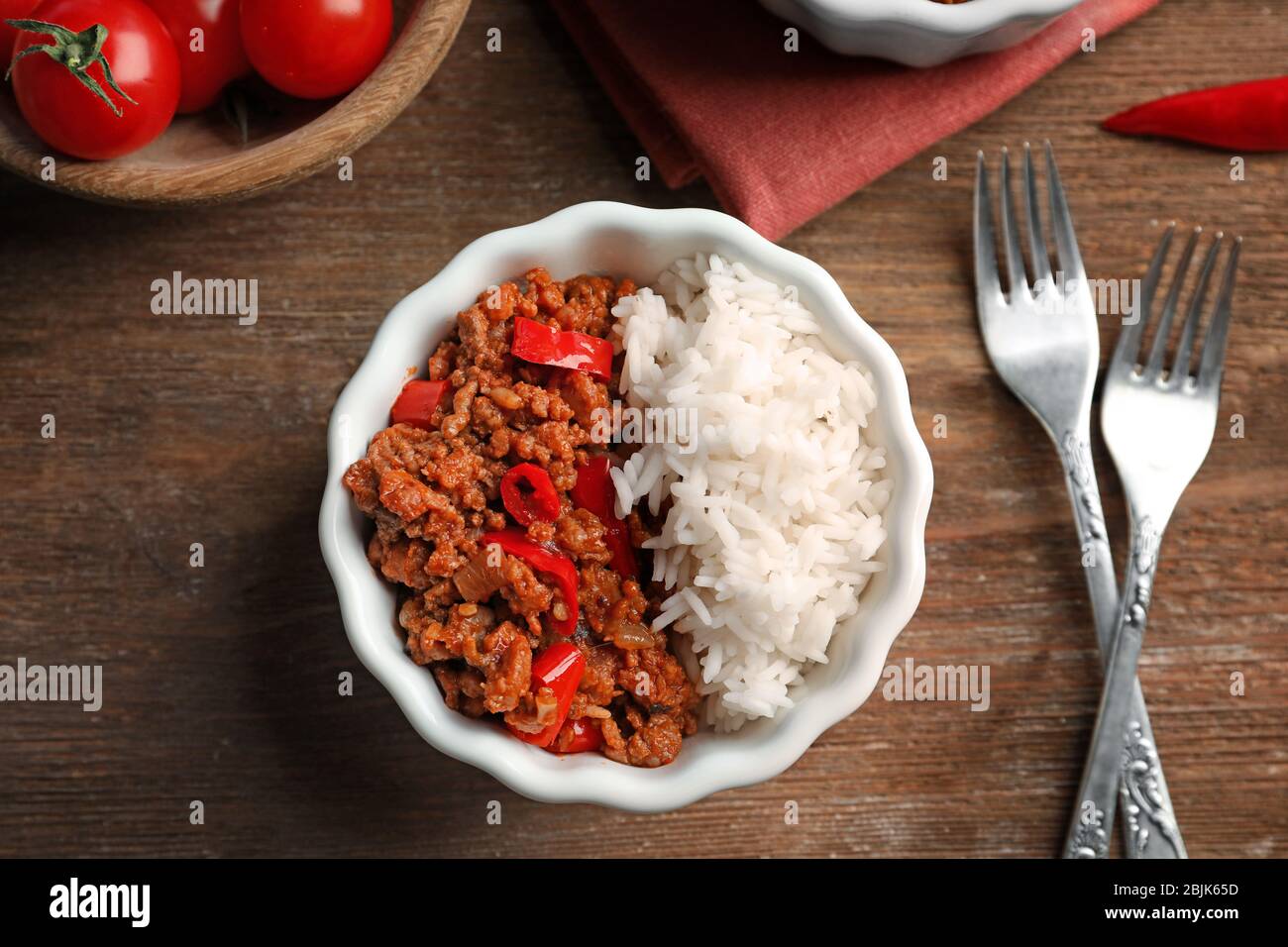 Chili Con Carne with rice in bowl on table Stock Photo - Alamy
