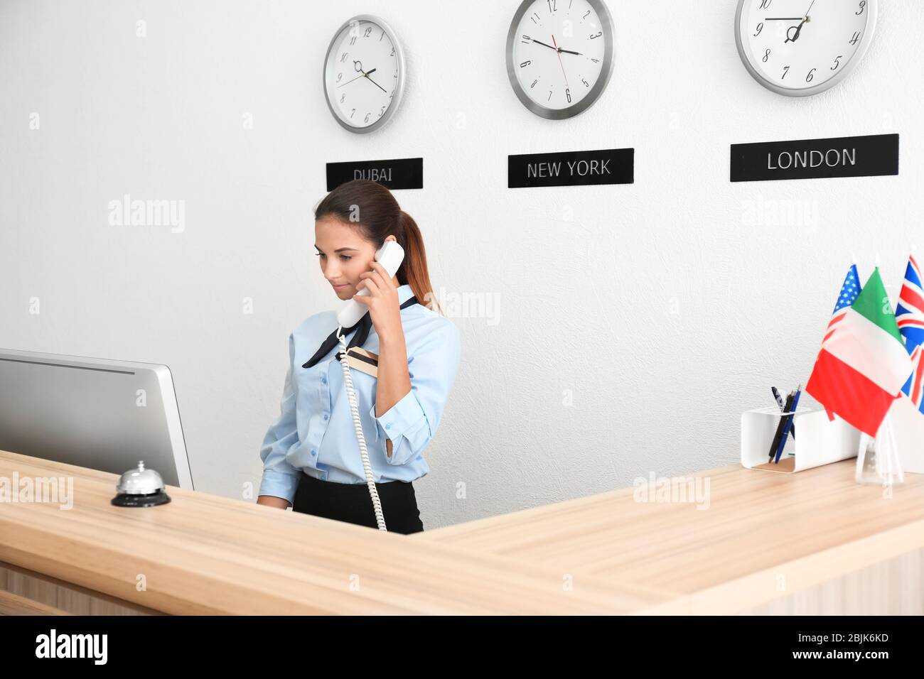 Female receptionist working in hotel Stock Photo - Alamy