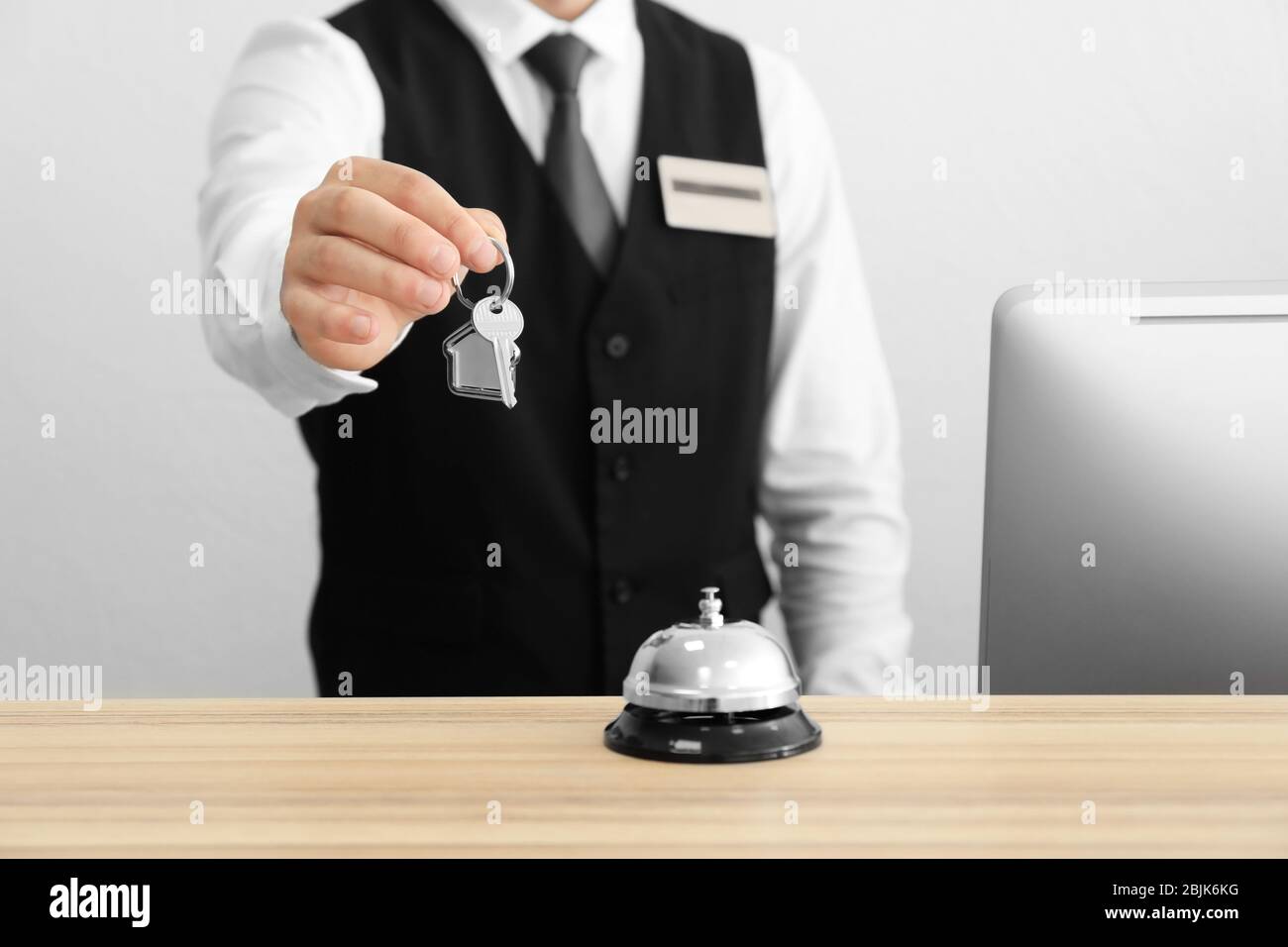 Male hotel receptionist handing hi-res stock photography and images - Alamy