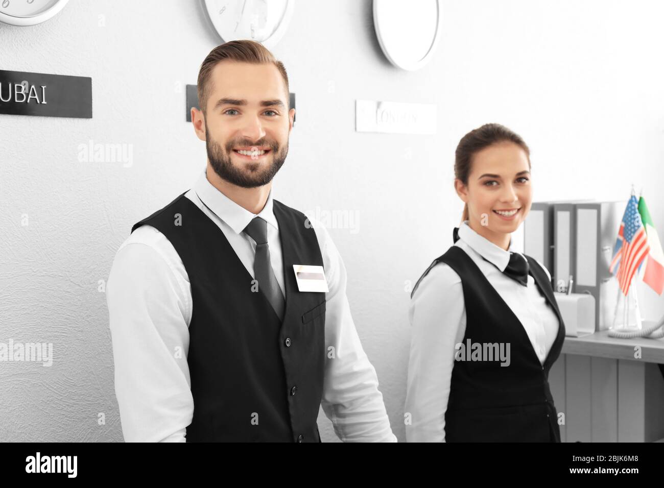 Two hotel receptionists at workplace Stock Photo - Alamy
