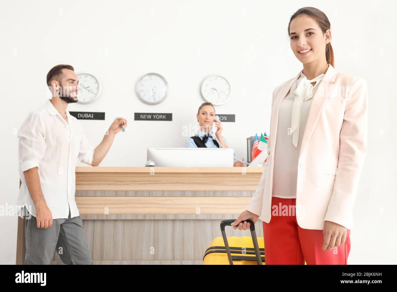 People standing at counter in hotel hi-res stock photography and images ...