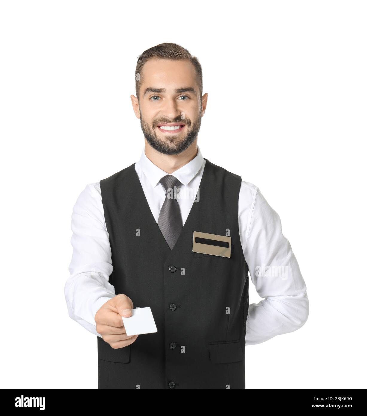 Male hotel receptionist handing card on white background Stock Photo ...