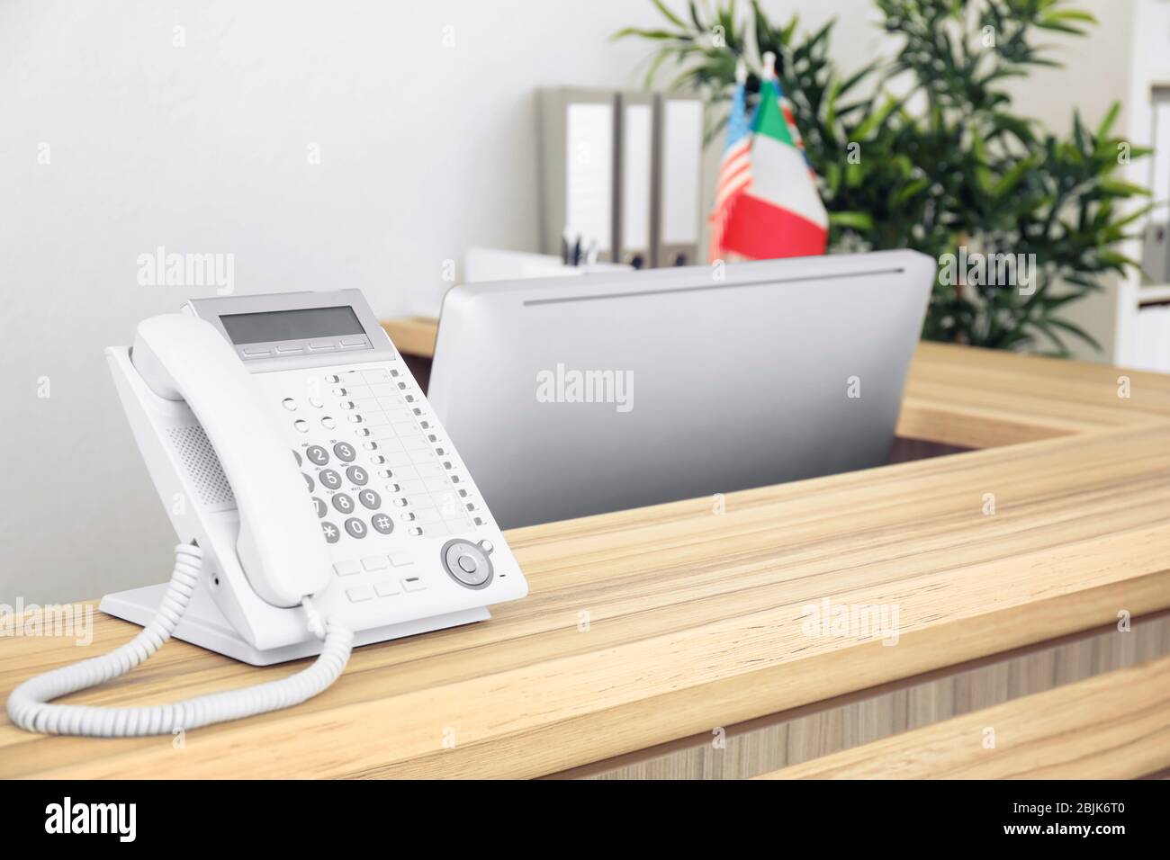 Stationary phone on reception desk in hotel Stock Photo - Alamy