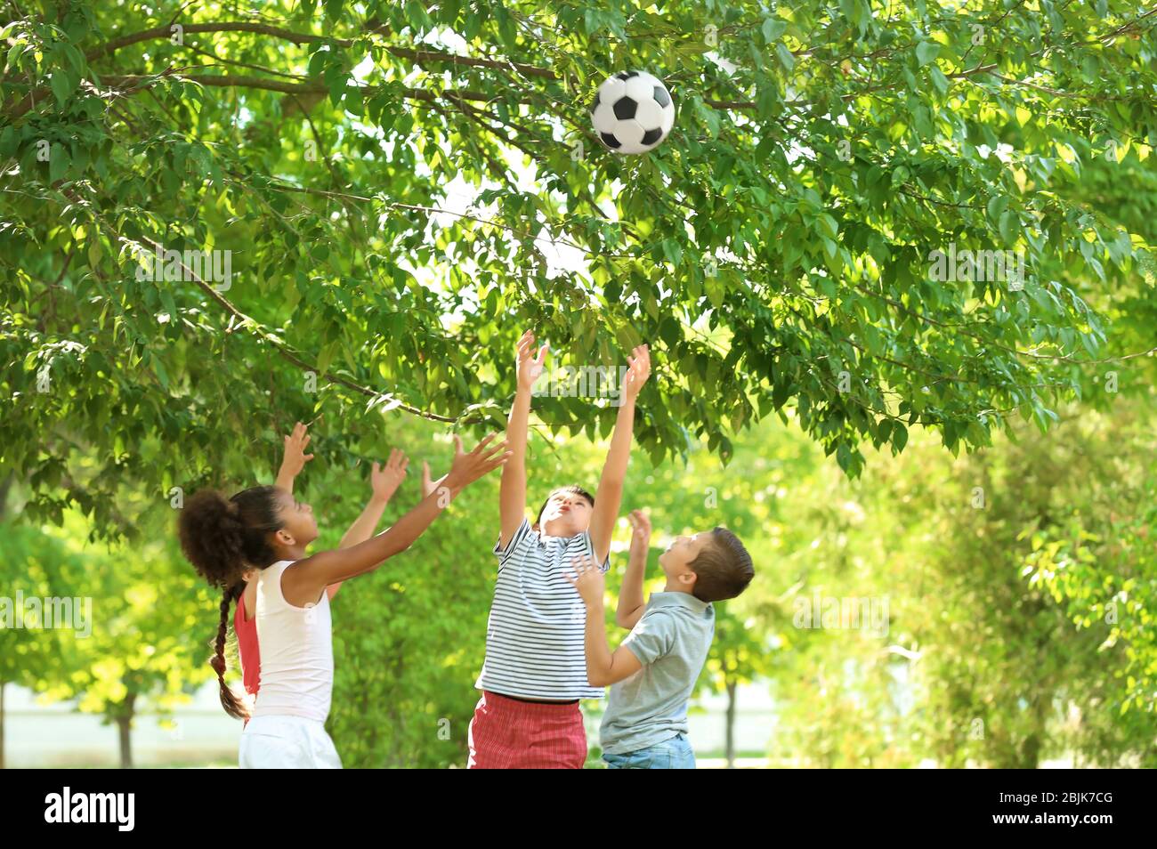 Cute children playing with ball in park Stock Photo - Alamy