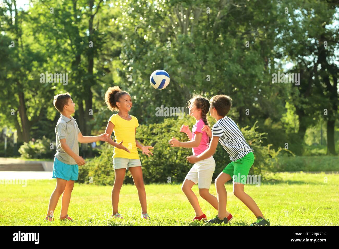 Cute children playing with ball in park Stock Photo - Alamy