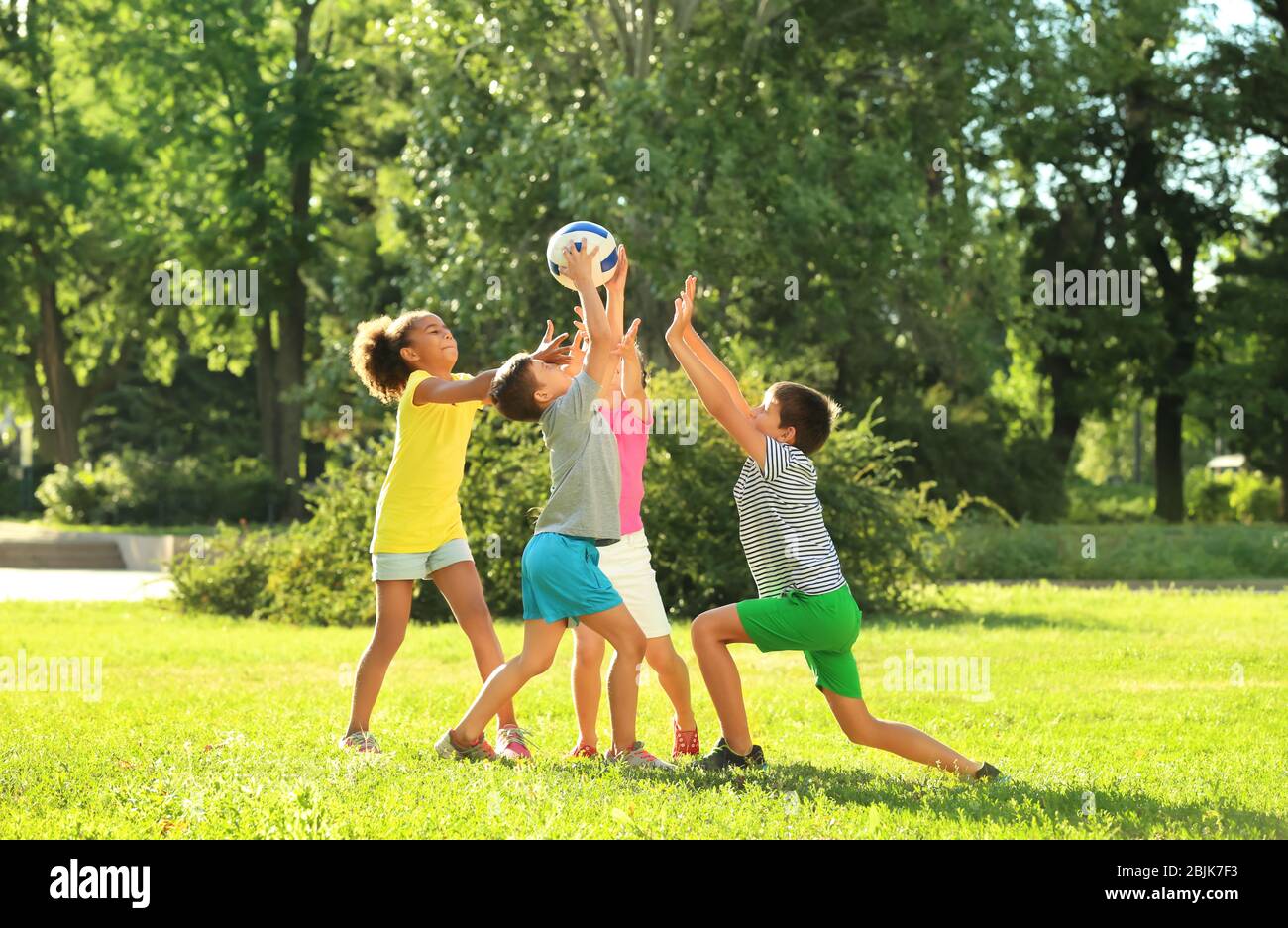 Cute children playing with ball in park Stock Photo - Alamy