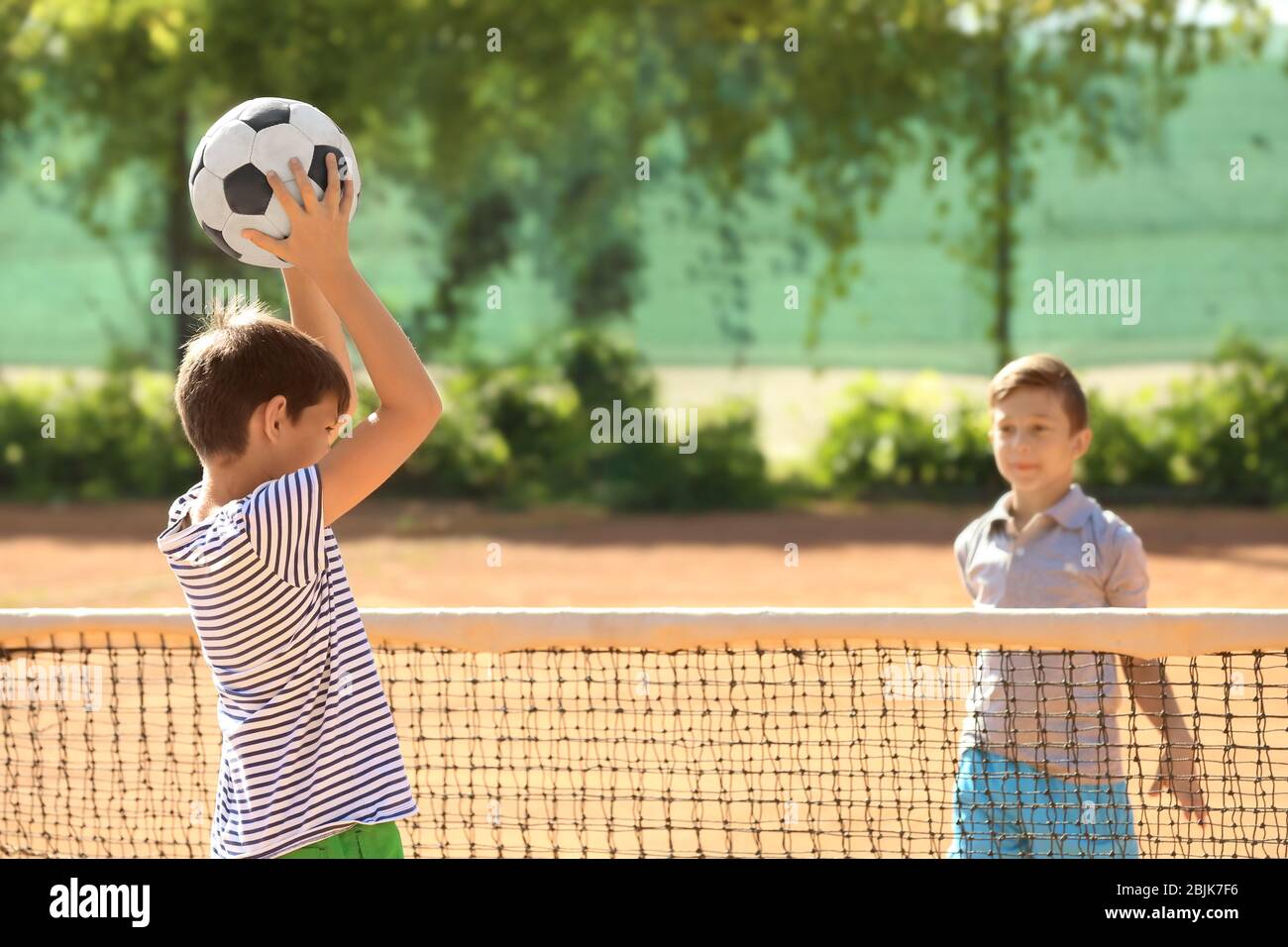 Cute children playing on sports ground outdoors Stock Photo - Alamy