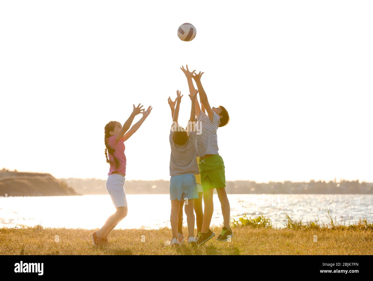 Cute children playing on river bank Stock Photo - Alamy