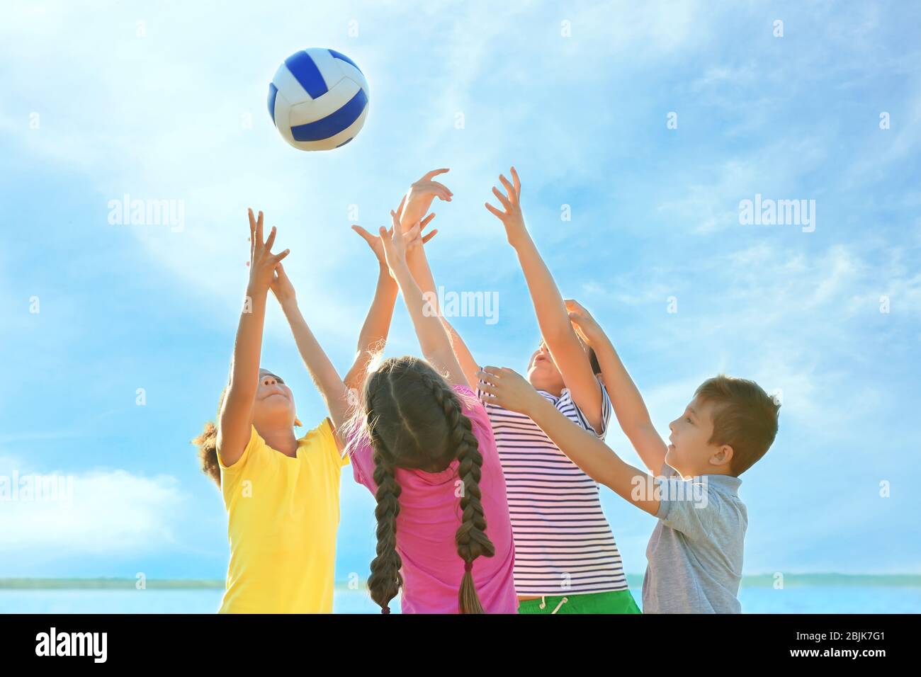 Cute children playing with ball outdoors Stock Photo - Alamy