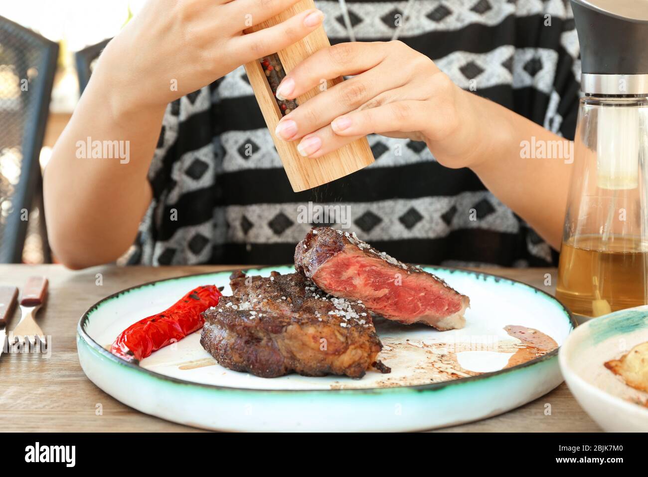 Woman adding salt restaurant hi-res stock photography and images - Alamy