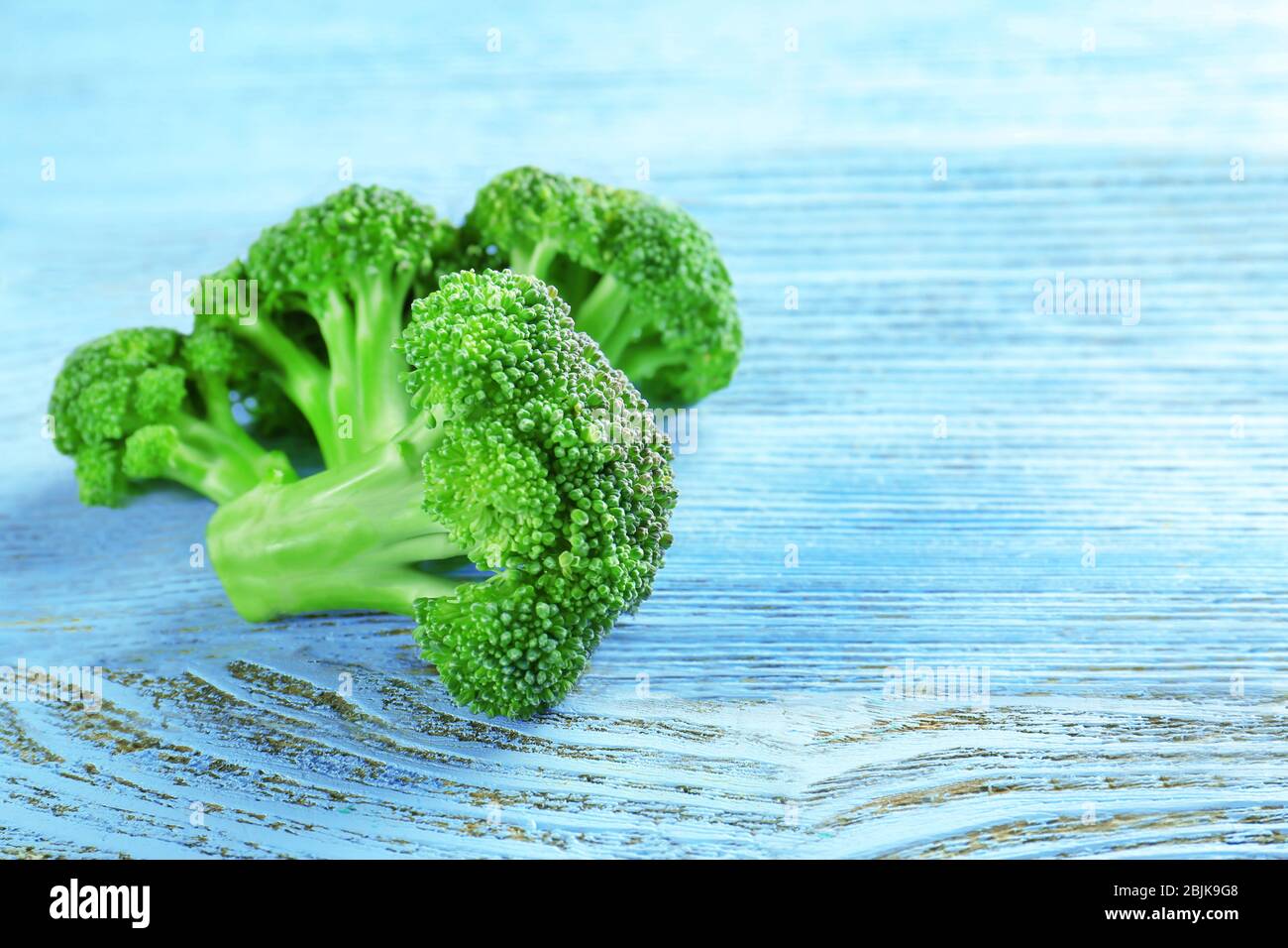 Fresh broccoli on wooden table Stock Photo - Alamy