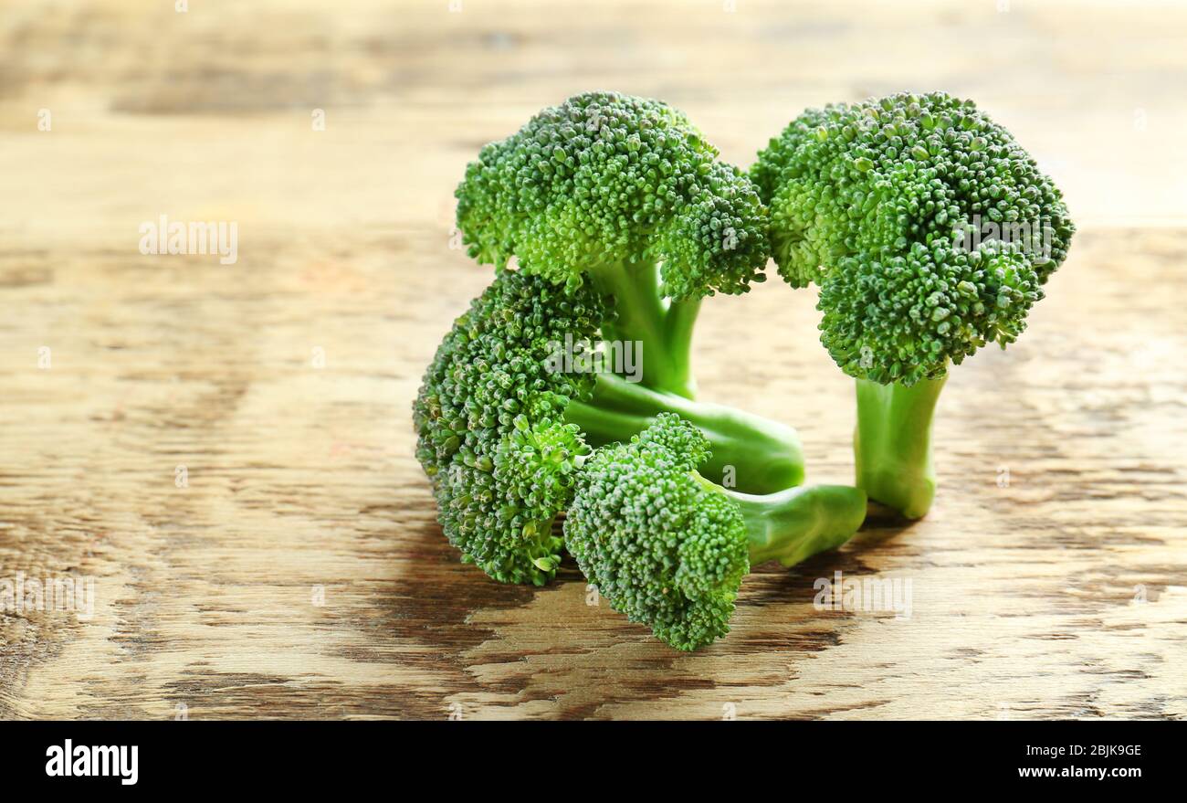 Fresh broccoli on wooden table Stock Photo - Alamy