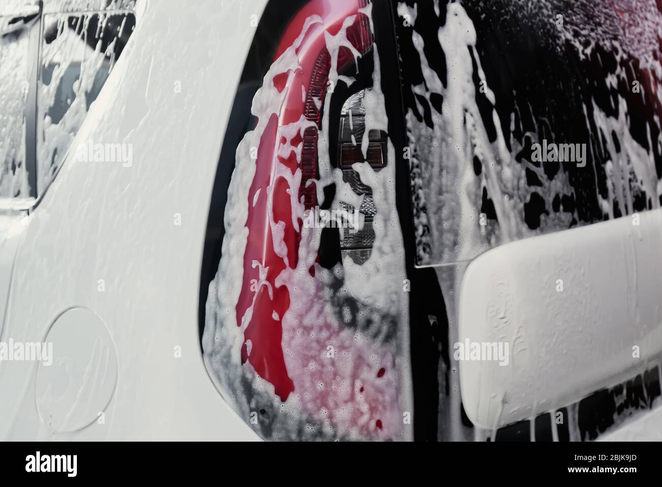 Rear window of automobile in foam at car wash Stock Photo - Alamy