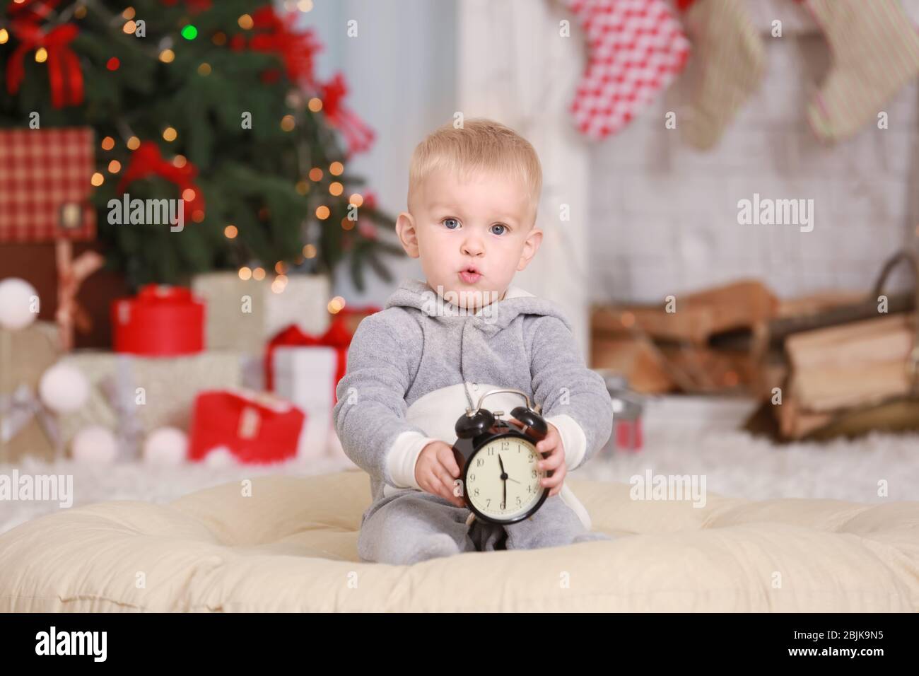Cute little baby with clock at home. Christmas countdown concept Stock ...