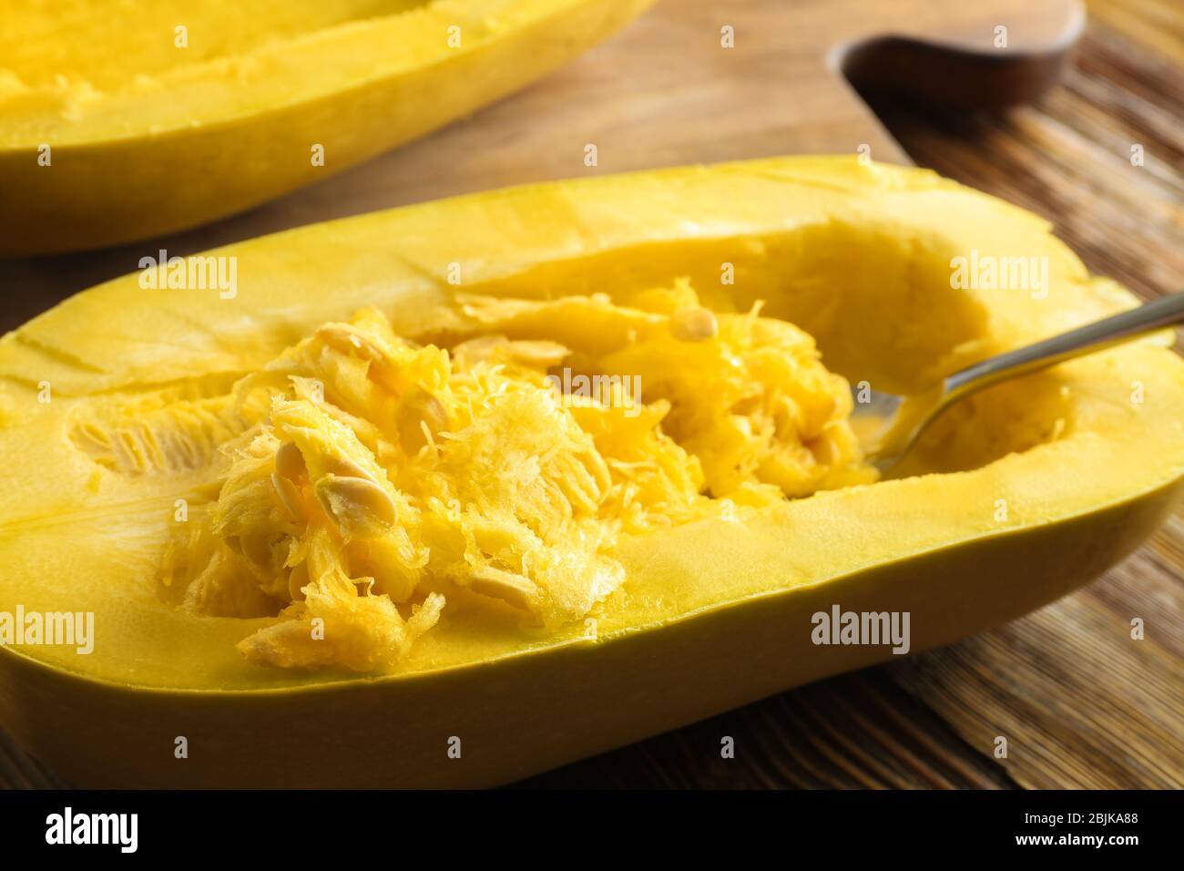 Fresh spaghetti squash with spoon on table, close up Stock Photo - Alamy