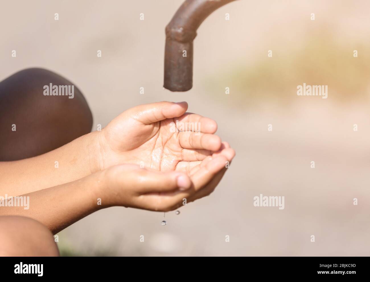 African American boy drinking water from tap, closeup Stock Photo - Alamy