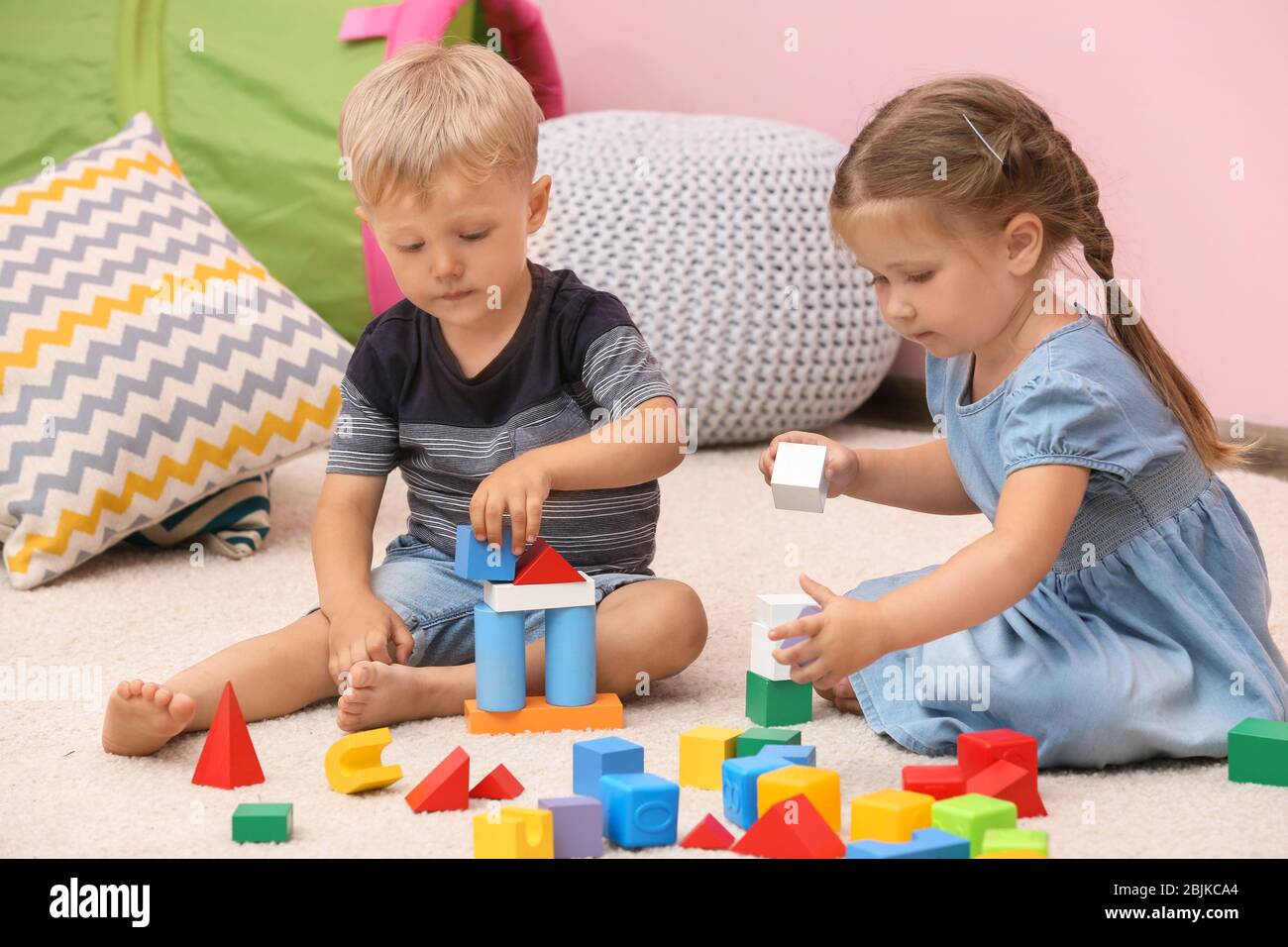 Cute children playing with constructor on floor at home Stock Photo - Alamy